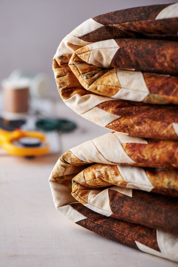 Folded Patchwork Blanket on White Wooden Surface on Sewing Accessories ...