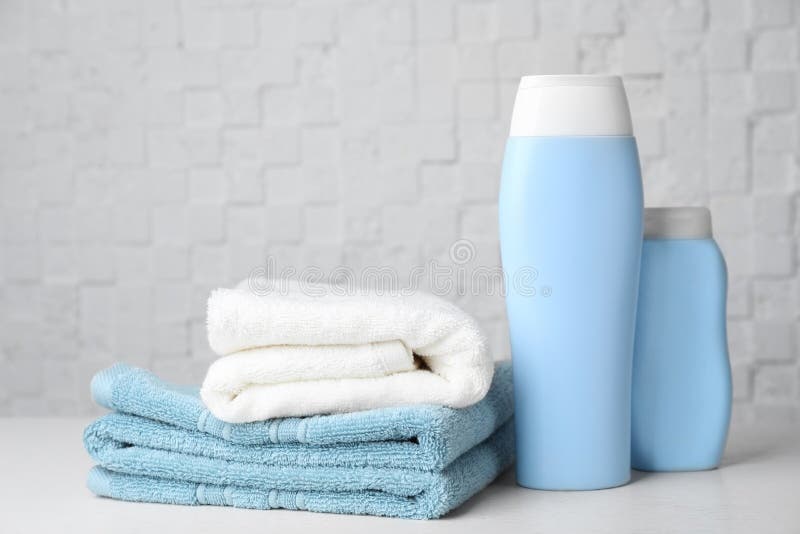 Folded Towels and Shampoo on Table Stock Photo - Image of household ...