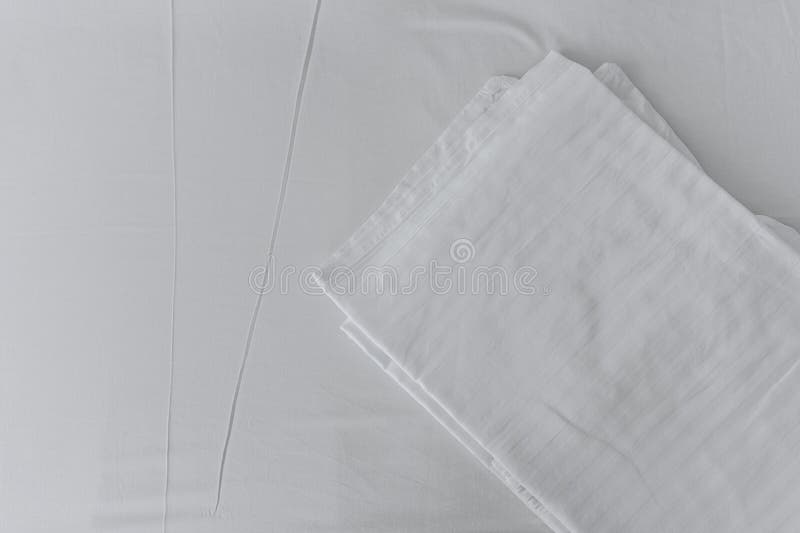 Folded White Bed Linens on Top of a Minimal Clean Bed with Soft Texture ...