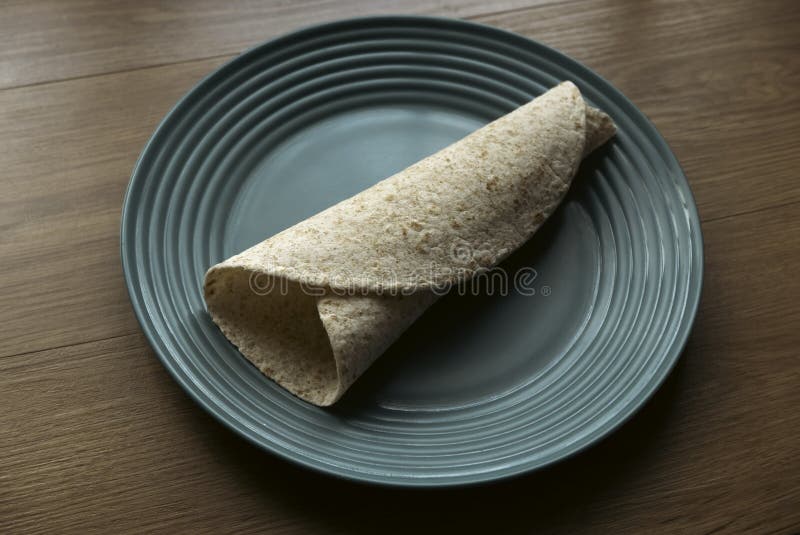 A Folded Wholegrain Wrap on a Green Plate Stock Image - Image of ...