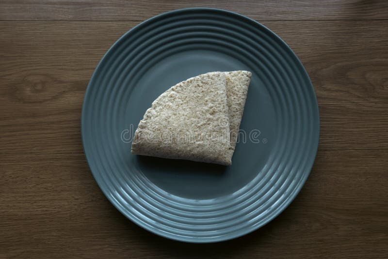 A Folded Wholegrain Wrap on a Green Plate Stock Image - Image of pile ...