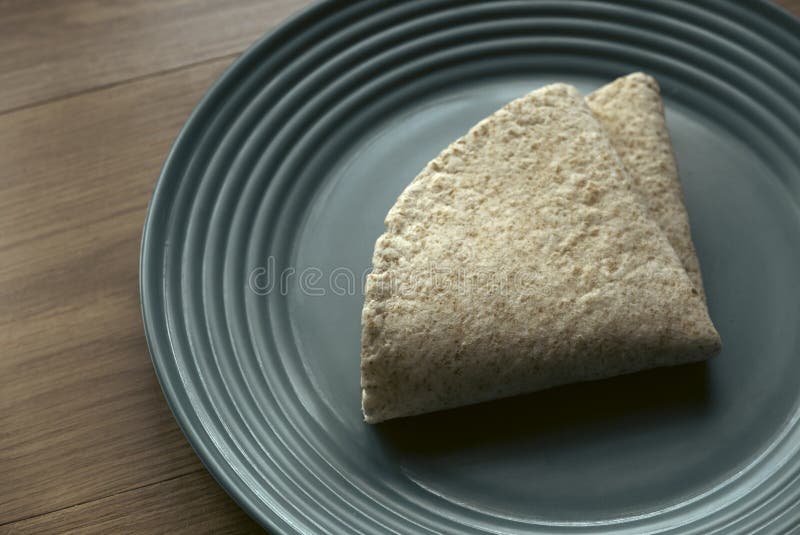 A Folded Wholegrain Wrap on a Green Plate Stock Photo - Image of empty ...