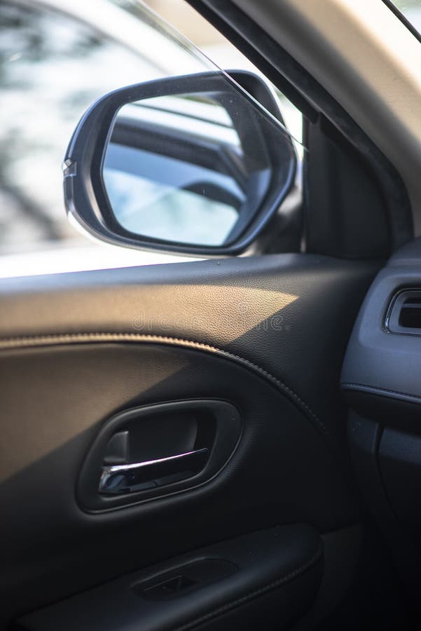 Folded Wing Mirror of a Compact Modern Car, with a Side Window Glass ...