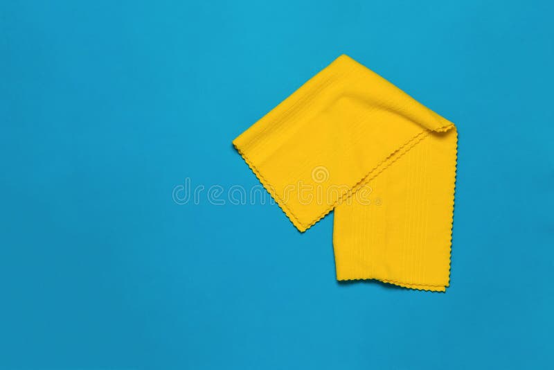 A Folded Yellow Rag on a Blue Background. Flat Lay Stock Image - Image ...