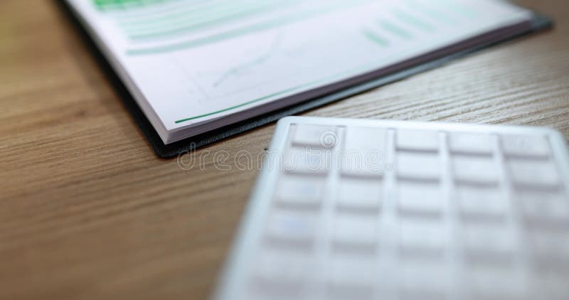 Folder with Chart Papers and White Calculator on Table Stock Footage ...