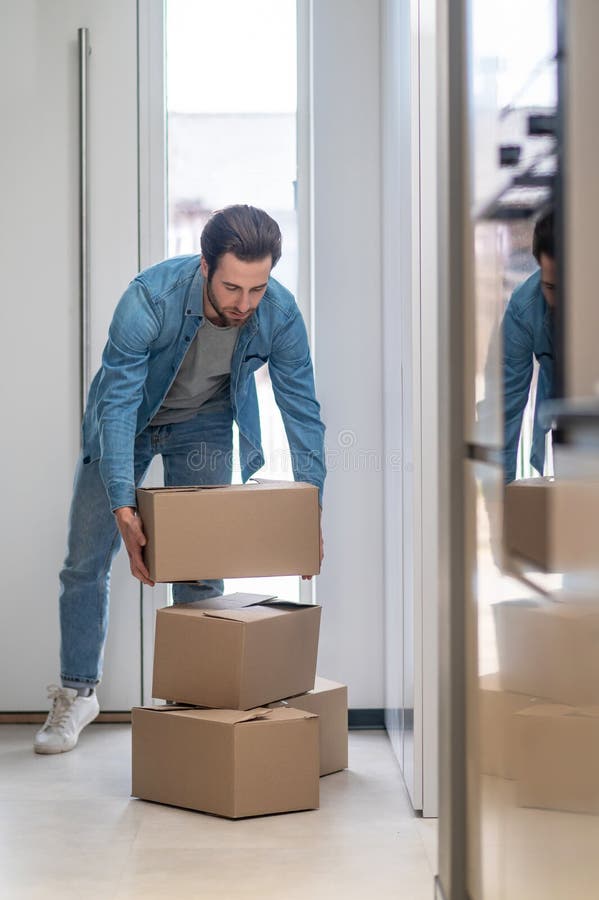 Man Bending Over Stack of Boxes Stock Photo - Image of apartment ...