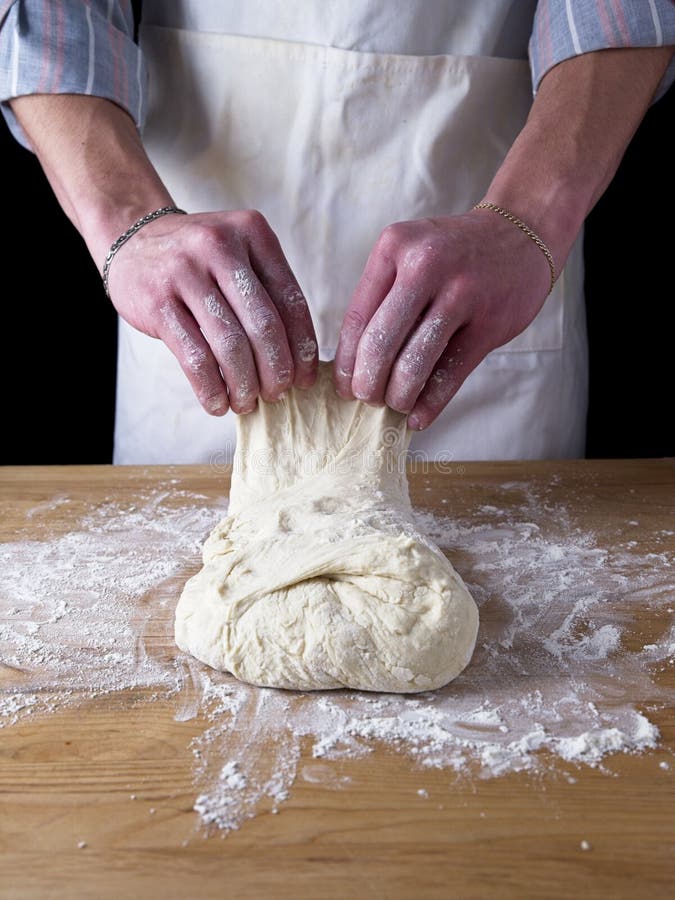 Folding dough on a table stock photo. Image of person - 353998036