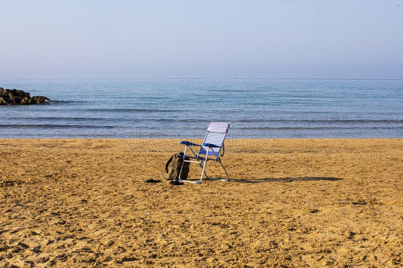 Folding Empty Sun Lounger with a Backpack on an Empty Snowy Beach I ...