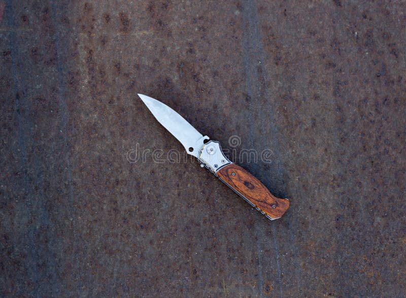 Folding Knife on Rusty Metal Background, Close Up Stock Photo - Image ...