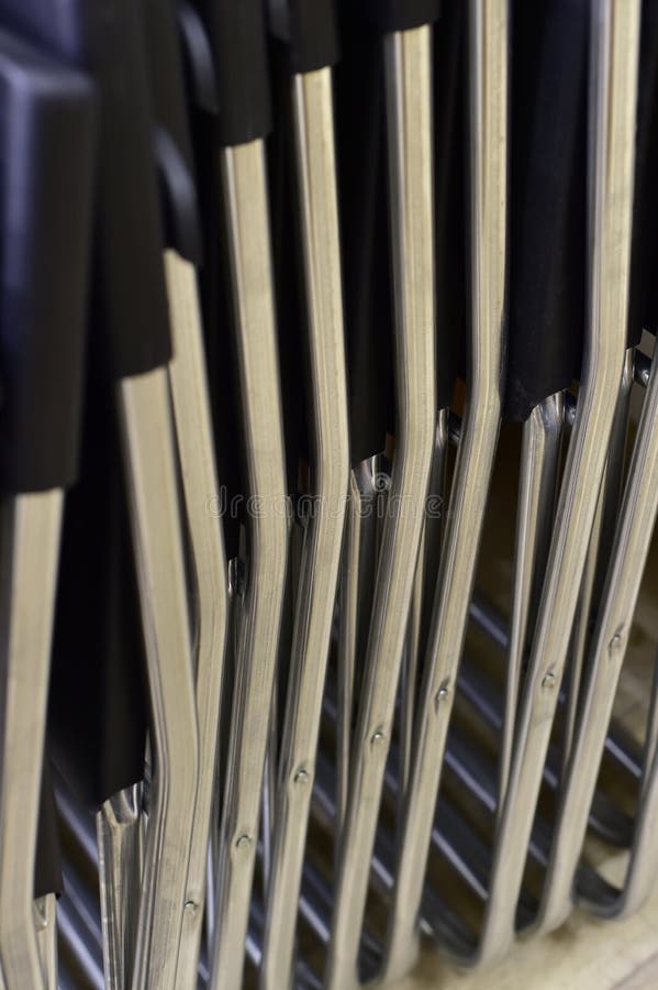Folding Metal Chairs Made of Tubes Stacked in a Row Stock Image - Image ...