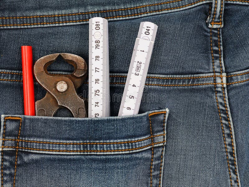 Folding Meter, Red Pencil and Pliers in the Back Pocket of a Denim ...