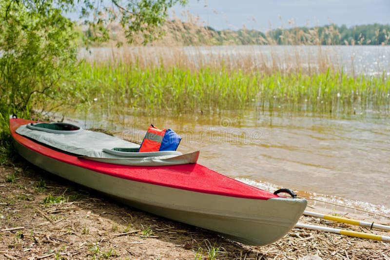 Red canoe on lake shore stock photo. Image of grass, recreation - 42075732