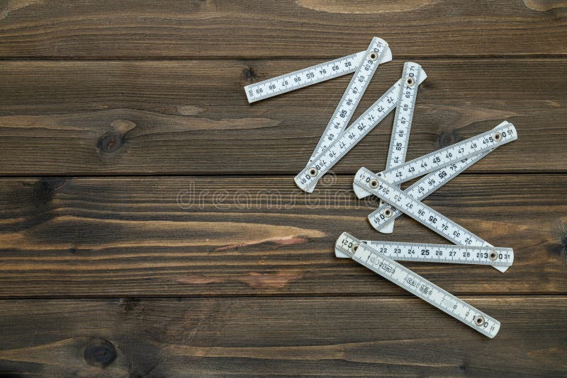 A Folding Ruler Lying on an Old Wooden Table of Dark Brown Color Stock ...