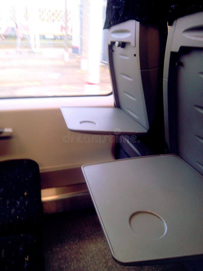 A Folding Tables Mounted in the Back of the Chair of a Railway Carriage ...