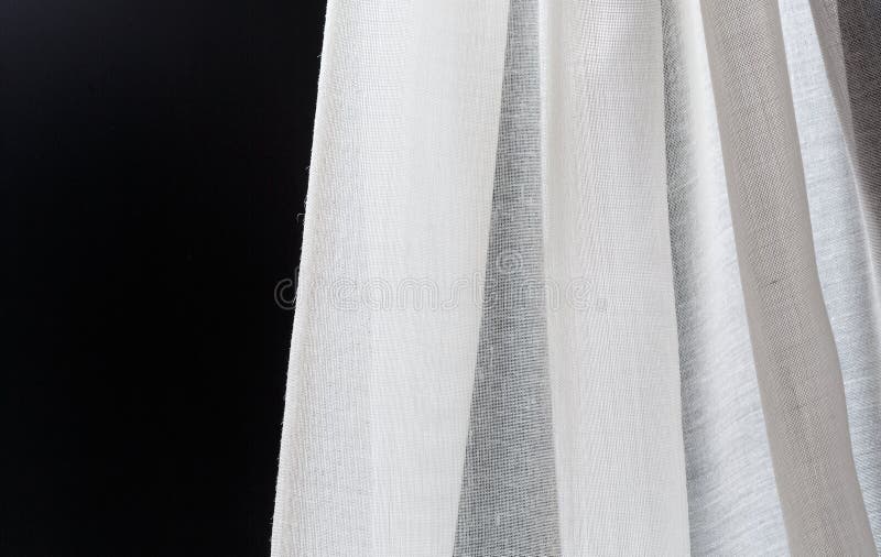 Folds of White Satin Cotton Transparent Textile on a Black Background ...