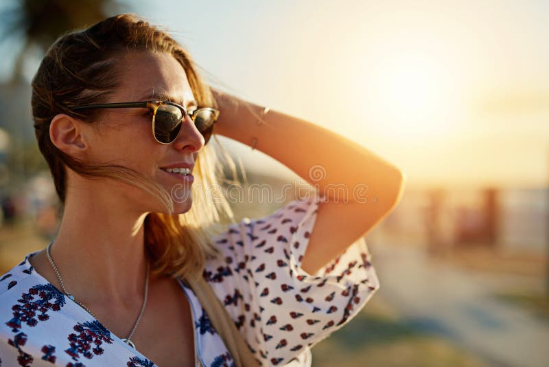 Following the Sun. Shot of a Young Woman on the Beach. Stock Image ...