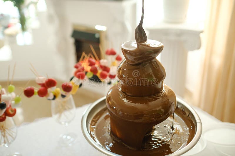 Fondue with a Chocolate Fountain and Sweets for it.Sweet Theme Stock ...