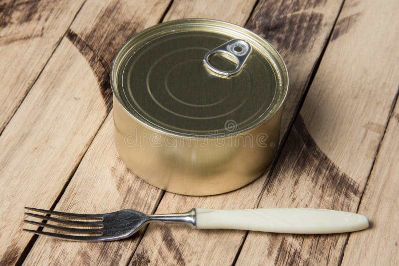 Food Can and Fork on a Wooden Table. Packaging, Product. Storage of ...
