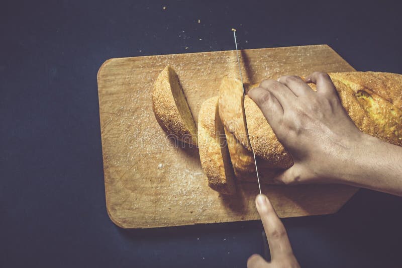 Food Concept. Hand Cutting Bread. Slicing a Bread Stock Image - Image ...