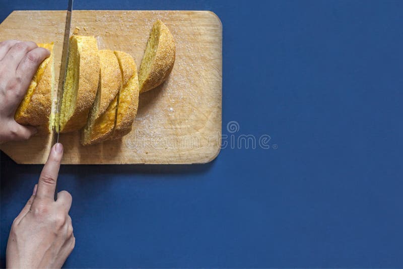 Food Concept. Hand Cutting Bread. Slicing a Bread Stock Photo - Image ...