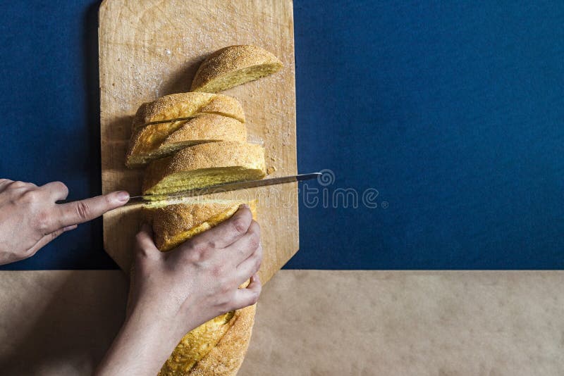 Food Concept. Hand Cutting Bread. Slicing a Bread Stock Photo - Image ...