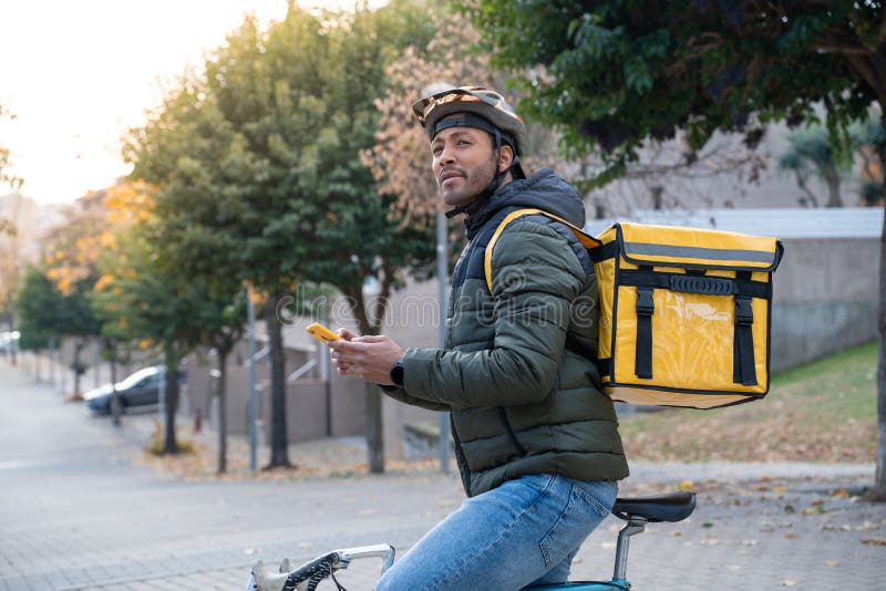 Food Delivery Concept. Young Black Man Driver with Backpack Looking ... Food Delivery Concept. Young Black Man Driver with Backpack Looking ...