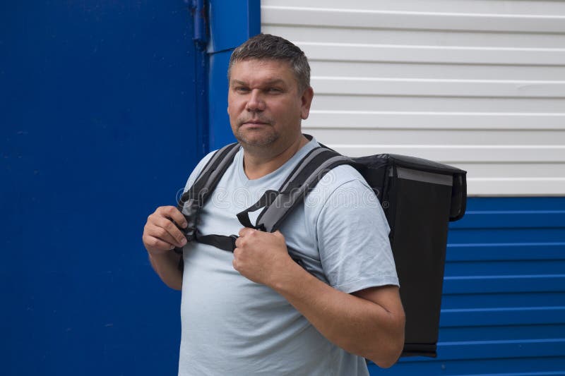 Food Delivery at Home.a Delivery Man with a Special Backpack Stock ...