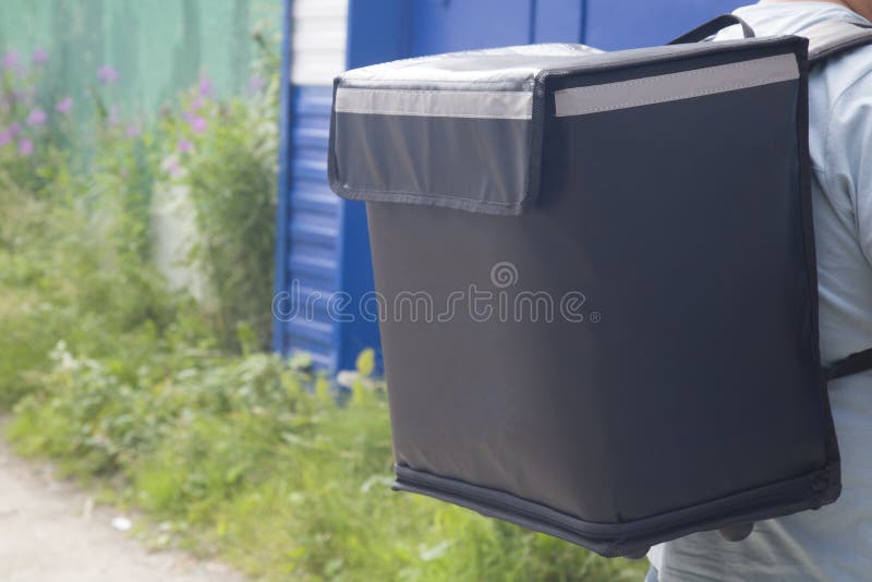 Food Delivery at Home.a Delivery Man with a Special Backpack Stock ...