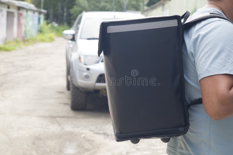 Food Delivery at Home.a Delivery Man with a Special Backpack Stock ...