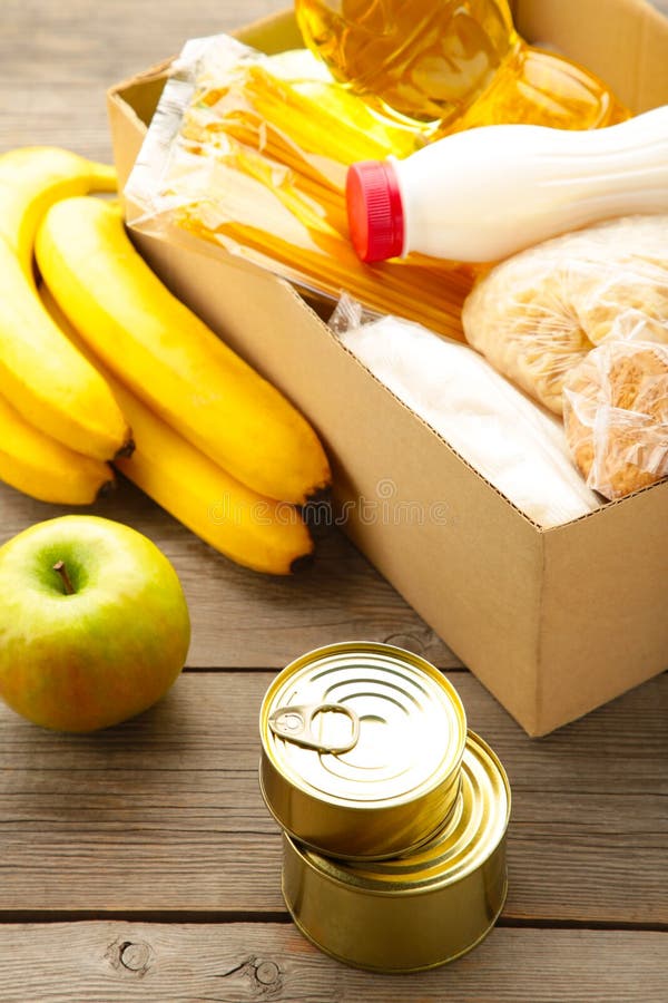 Food Donations on the Grey Wooden Background. Top View Stock Photo ...