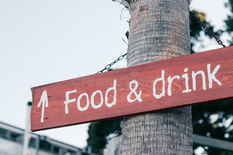 Food and Drink Sign on a Tree Pointing Straight Stock Image - Image of ...