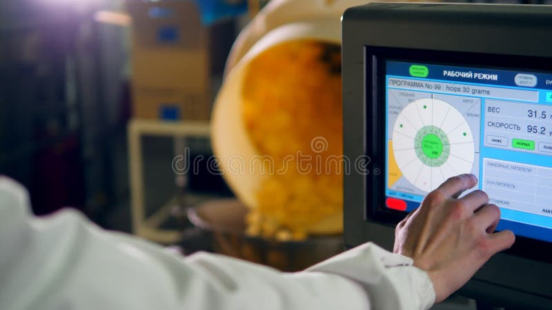 Food Factory Worker Types on a Machine, Controlling a Conveyor with ...