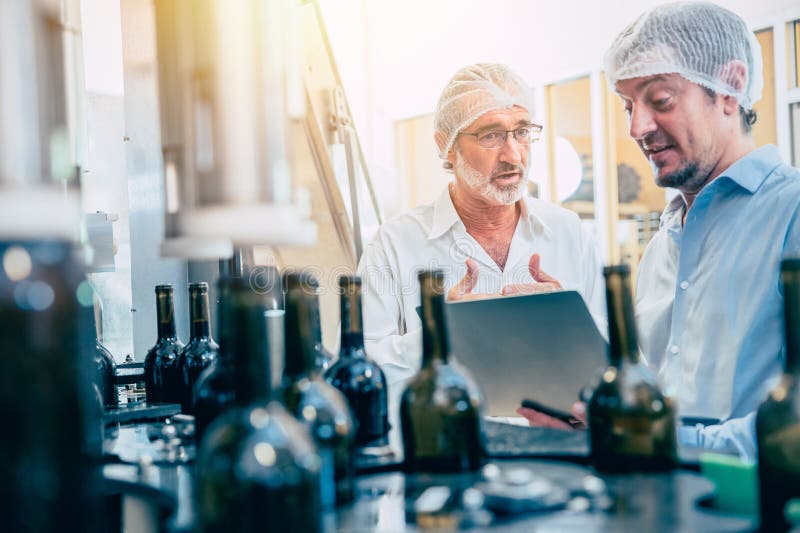 Food Production Process Inspector Team Working in Beverage Bottle ...