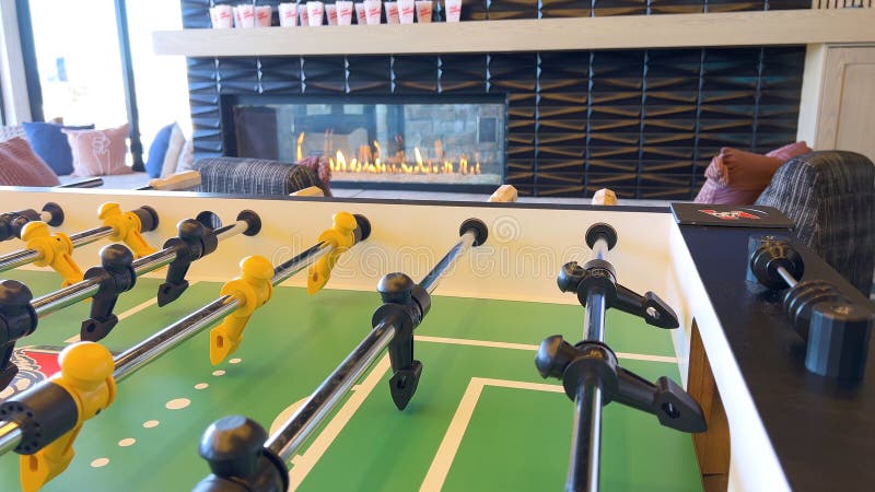 Cozy Indoor Leisure Time with Foosball Table and Fireplace Stock Photo ...