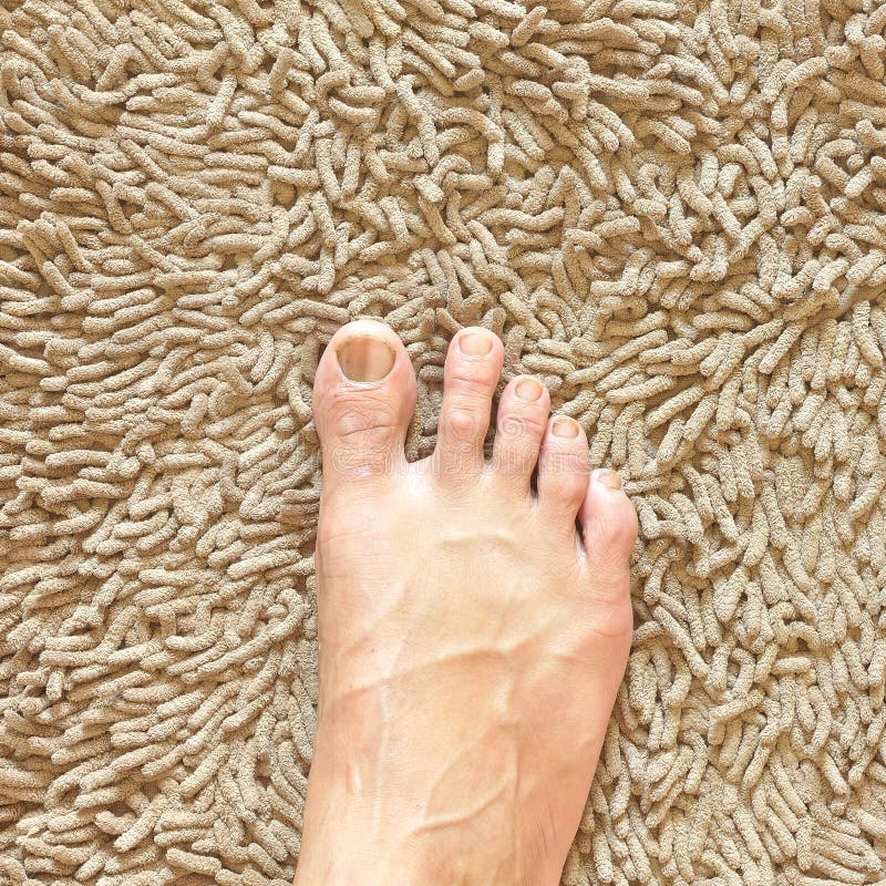 Foot on beige carpet stock image. Image of body, material - 45480105