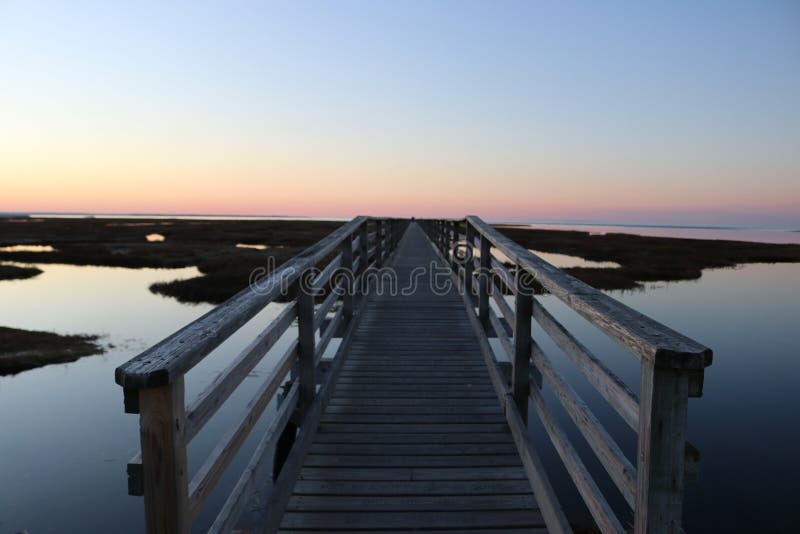 Foot Bridge Over Still Water Stock Photo - Image of glowing, rocks ...