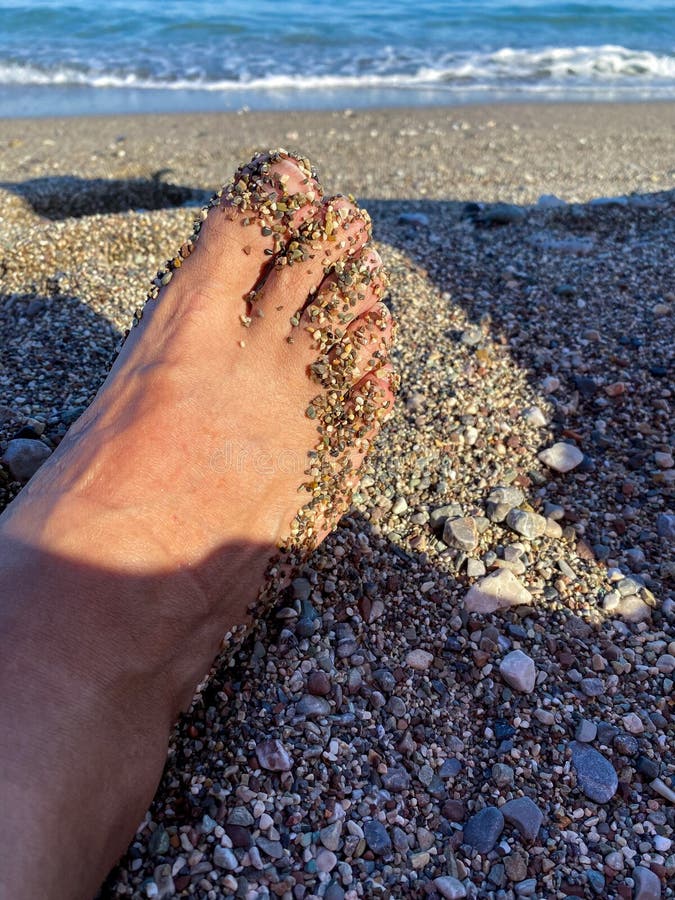 A Foot Covered in Sand by the Sea Stock Photo - Image of people ...