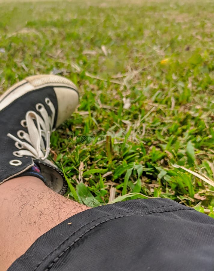 Tired foot in the grass stock image. Image of yellow - 261693255