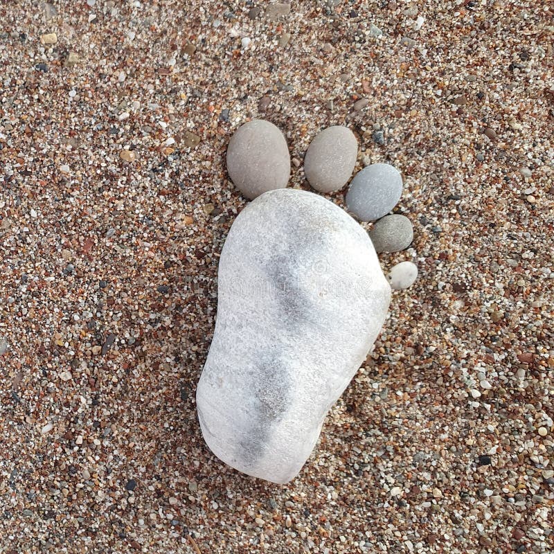 Foot Made of Pebbles on the Sea Sand. Stock Image - Image of water ...