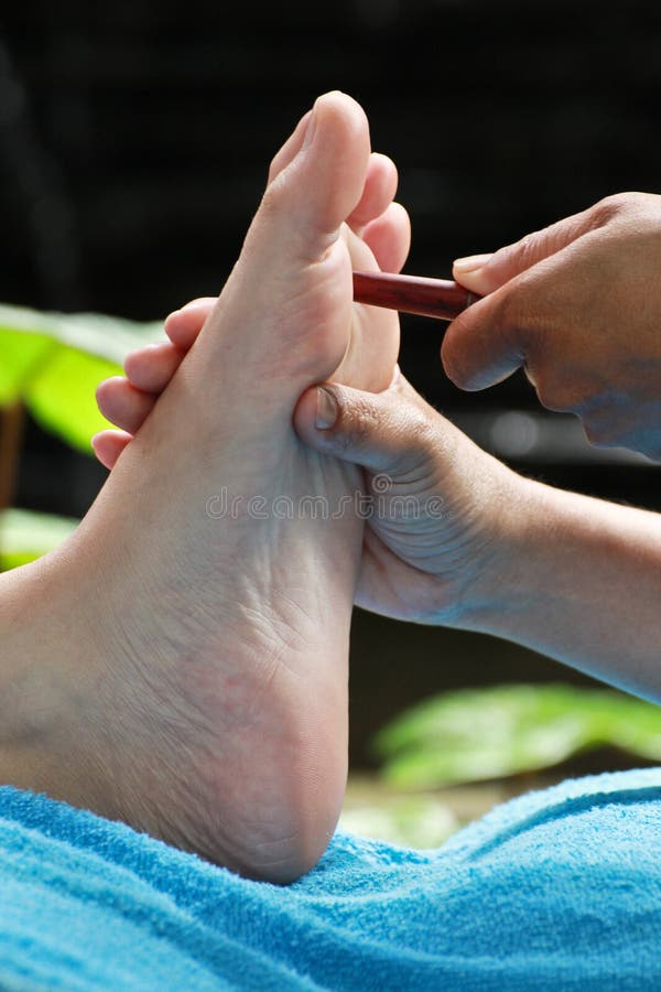 Foot massage by wood stick stock image. Image of restore - 35117343