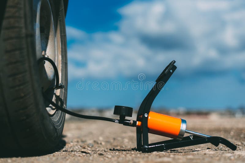 Foot Pump on the Floor Next To the Car and Wheel Stock Photo - Image of ...