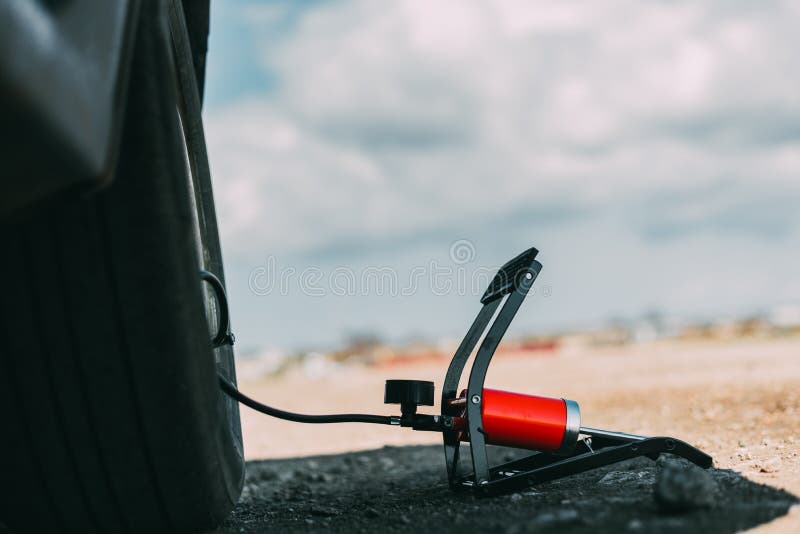 Foot Pump on the Floor Next To the Car and Wheel Stock Photo - Image of ...