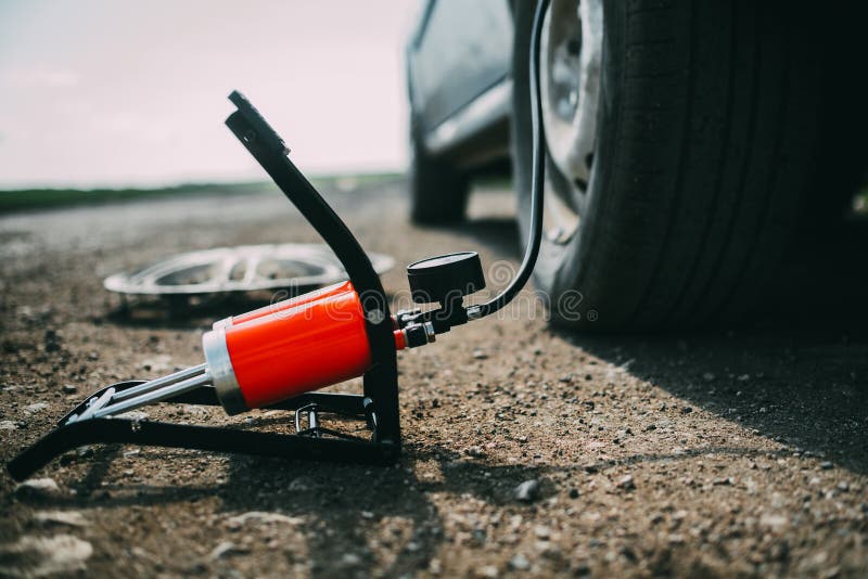 Foot Pump on the Floor Next To the Car and Wheel Stock Image - Image of ...