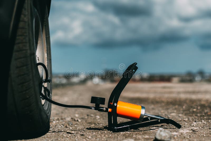Foot Pump on the Floor Next To the Car and Wheel Stock Photo - Image of ...