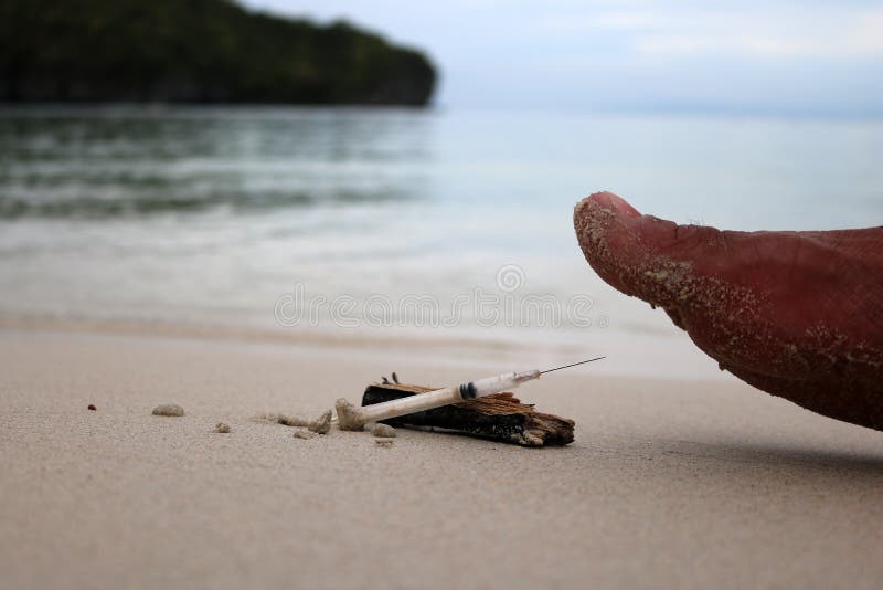 Foot Step On Injection Needles On The Beach. Stock Photo - Image of ...