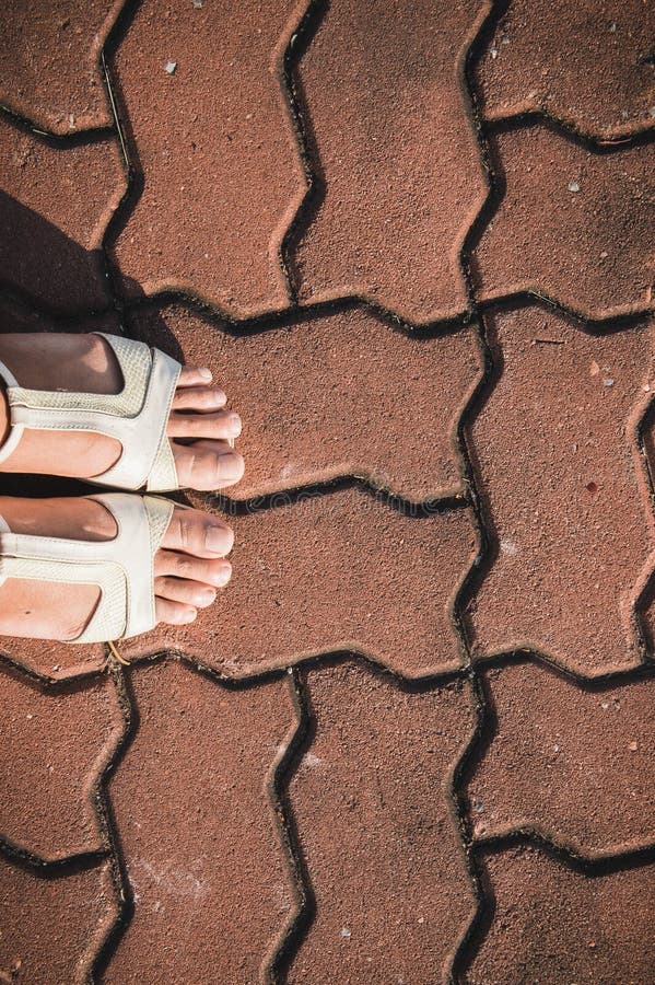 Foot Woman Shoe on the Texture Paving Stone Footpath Background Stock ...