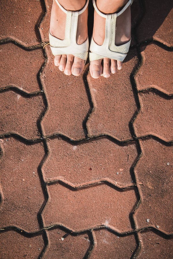 Foot Woman Shoe on the Texture Paving Stone Footpath Background Stock ...