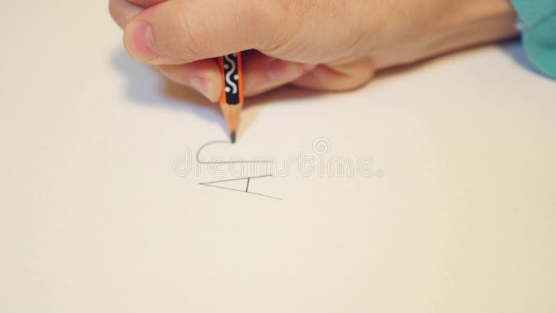 Footage of a Child Writing the First Letters of the Alphabet on a Sheet ...