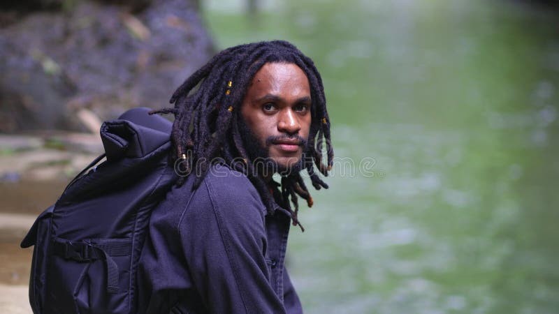 A Young Black Man with Dreadlocks Splashing Water in a River Stock ...