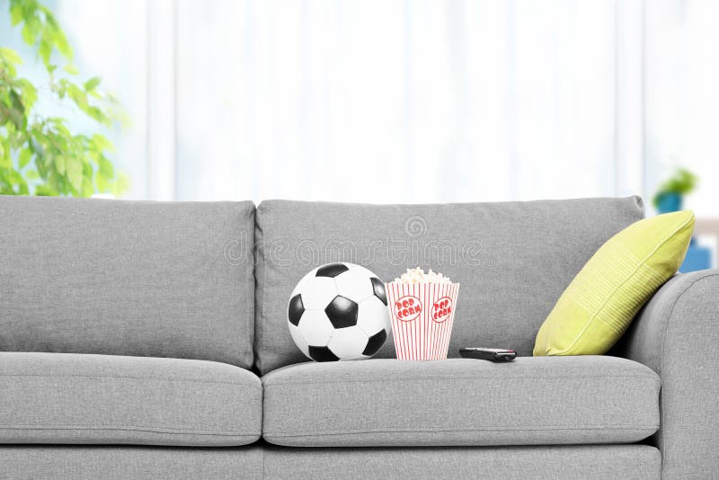 Football and a Box of Popcorn on a Modern Sofa Stock Image - Image of ...